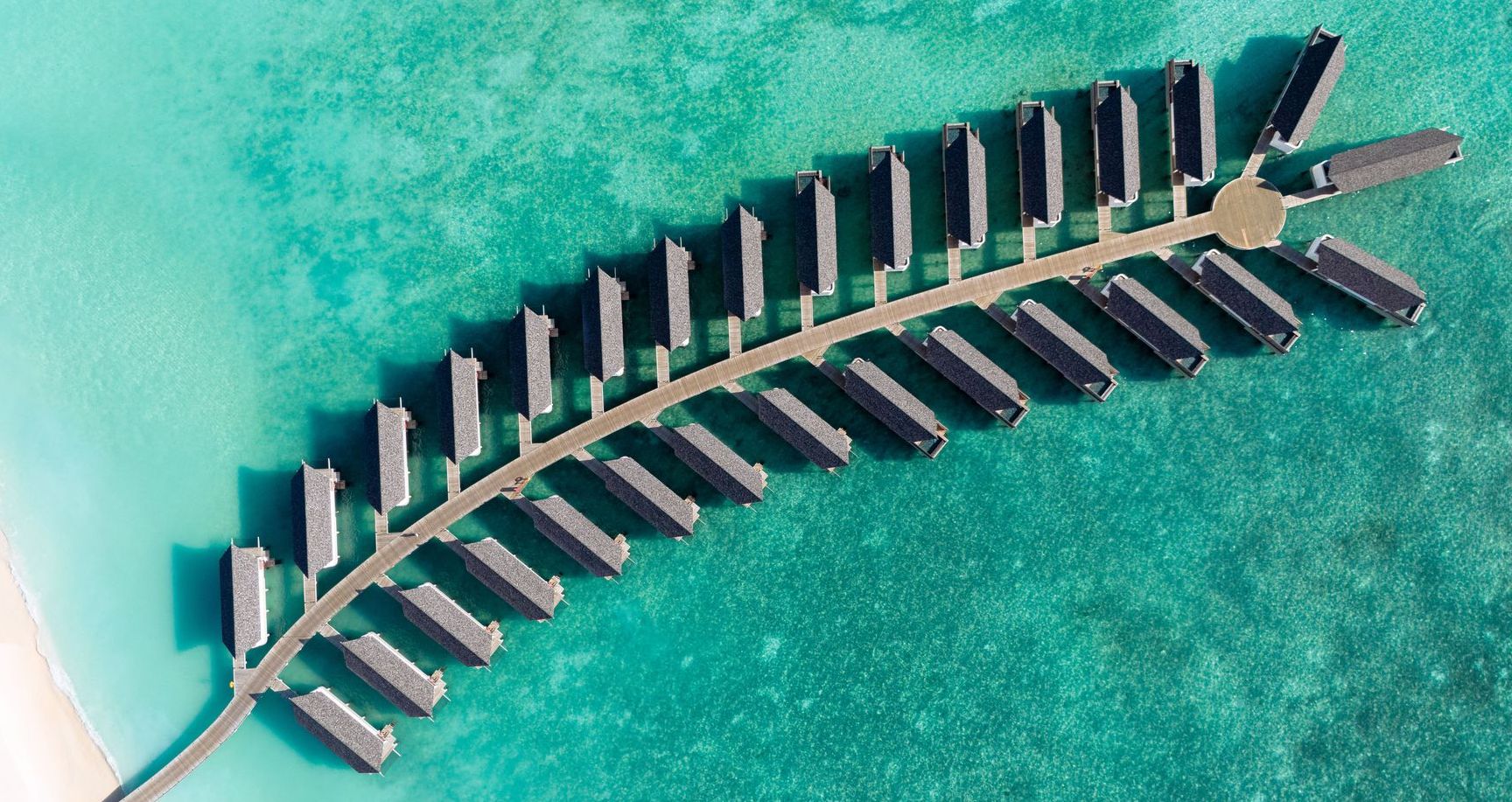 Overwater bungalows in the Maldives, surrounded by crystal-clear ...