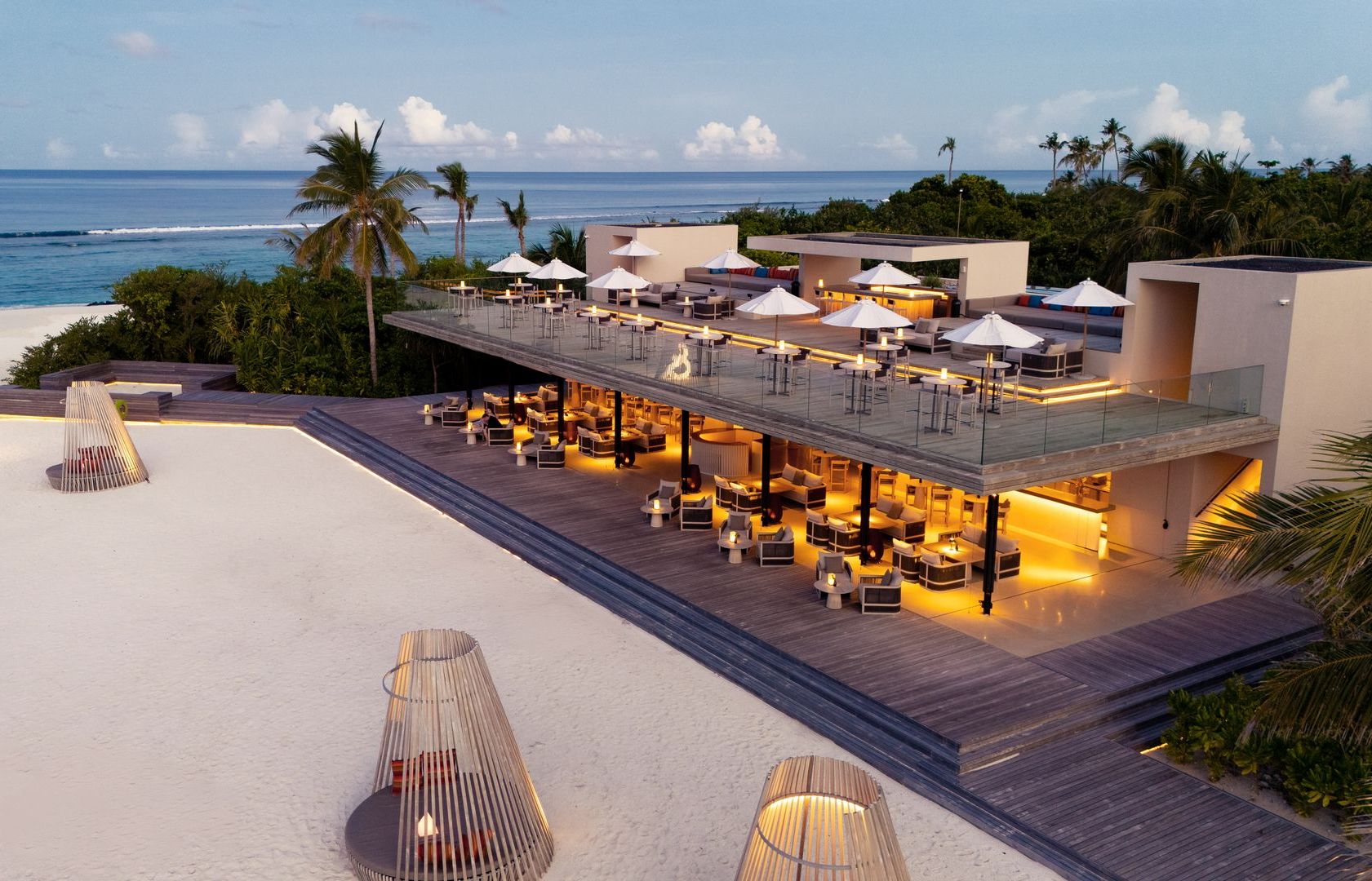 Beach club at resort in Maldives, with palm trees, white sand, and ...
